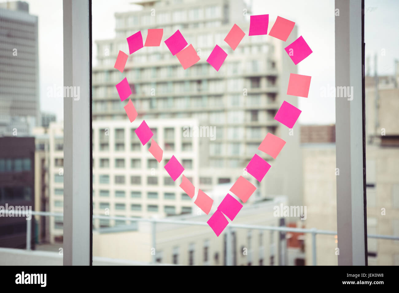 Heart in post-it on a window Stock Photo - Alamy