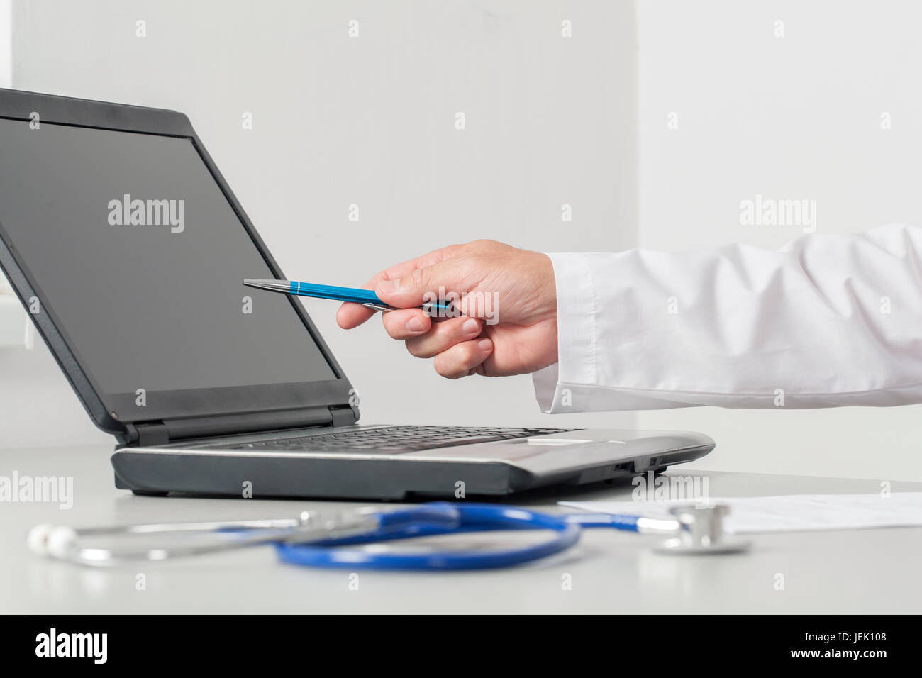 Doctor practitioner pointing showing by the hand to the computer screen ...
