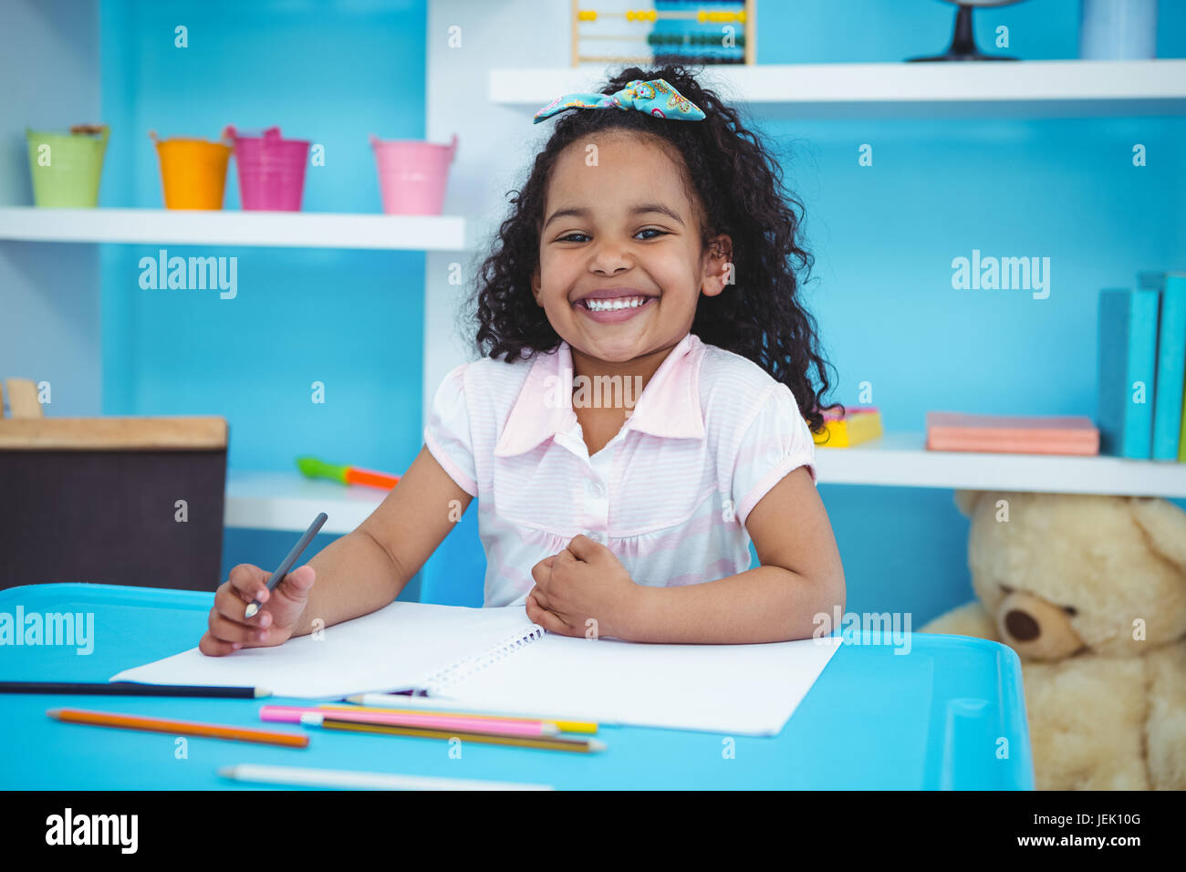 Cute girl writing on notebook Stock Photo - Alamy
