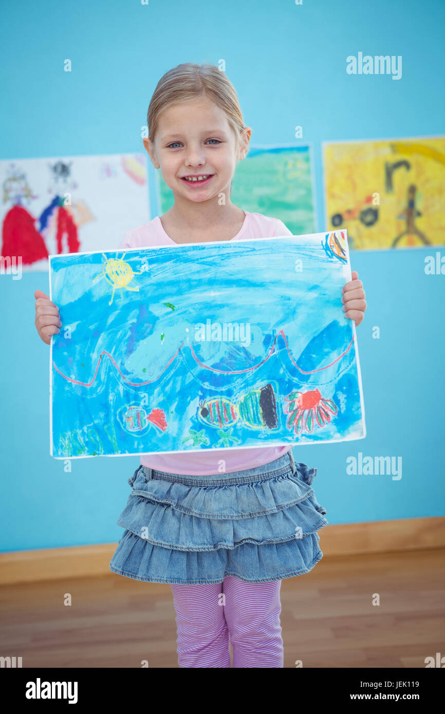 Cute girl showing her drawing Stock Photo - Alamy