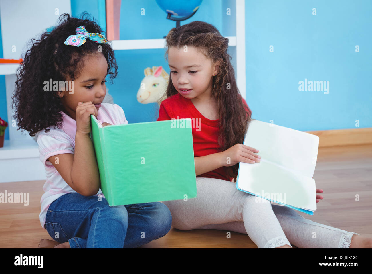 Cute girls holding books Stock Photo - Alamy