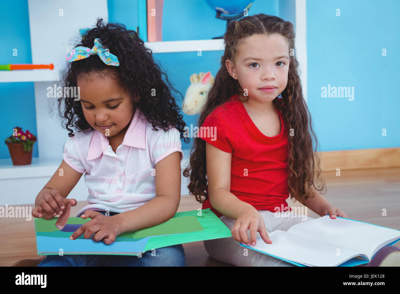 Cute girls holding books Stock Photo - Alamy