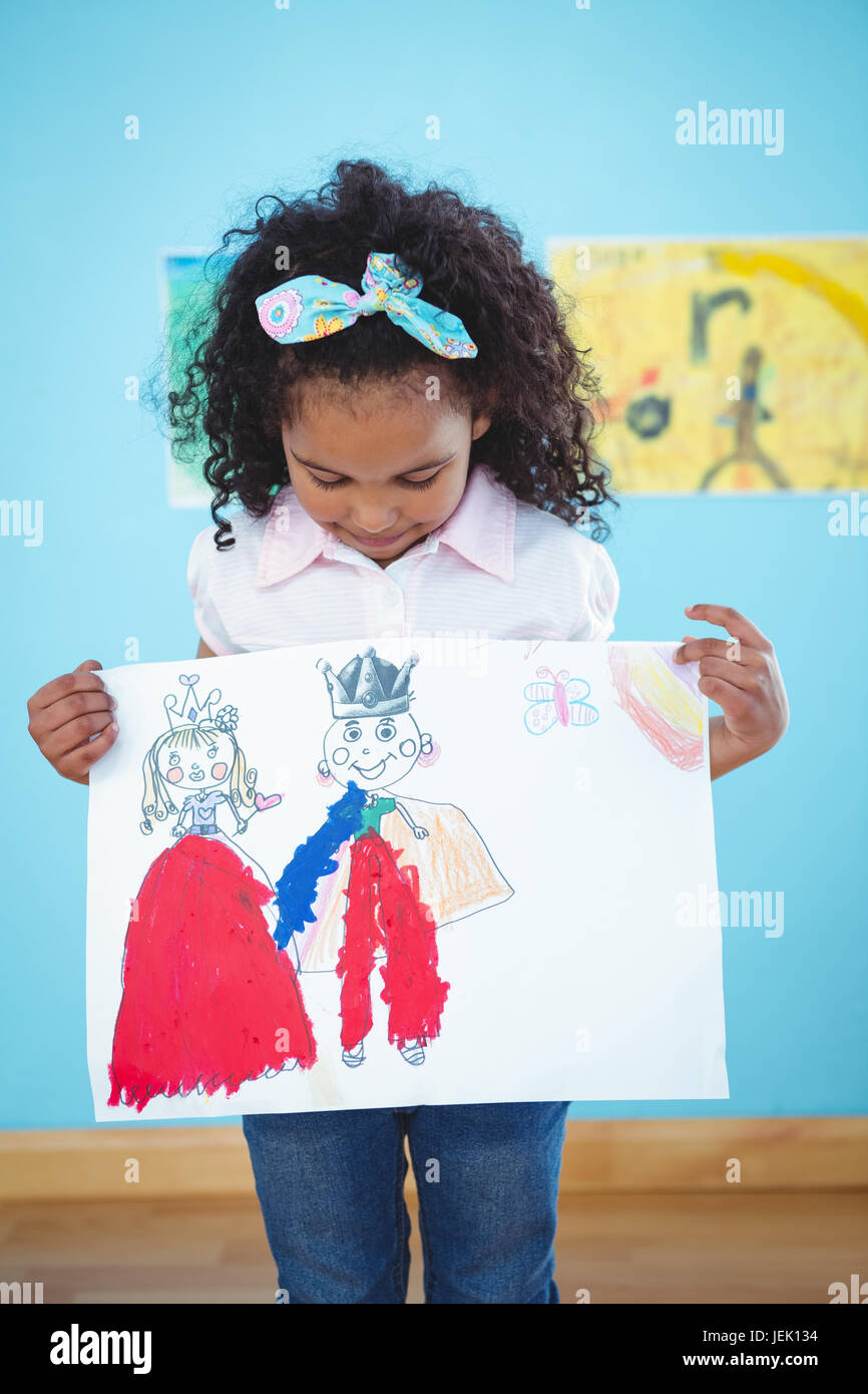 Cute girl showing her drawing Stock Photo - Alamy