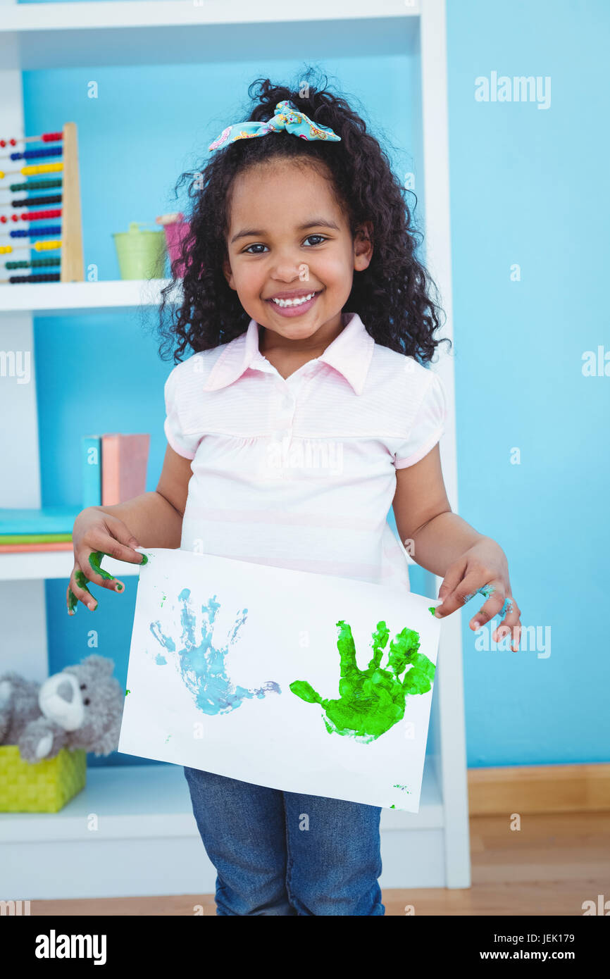 Cute girl showing paper with colored hands prints on it Stock Photo - Alamy