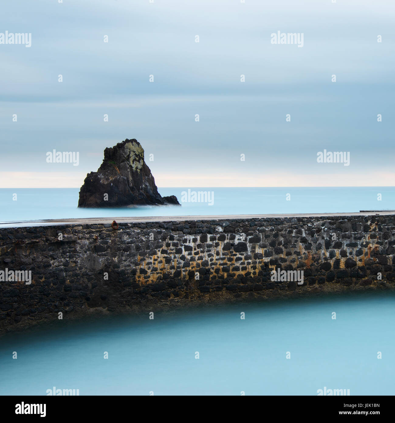 Stone wall and rock at sea Stock Photo - Alamy