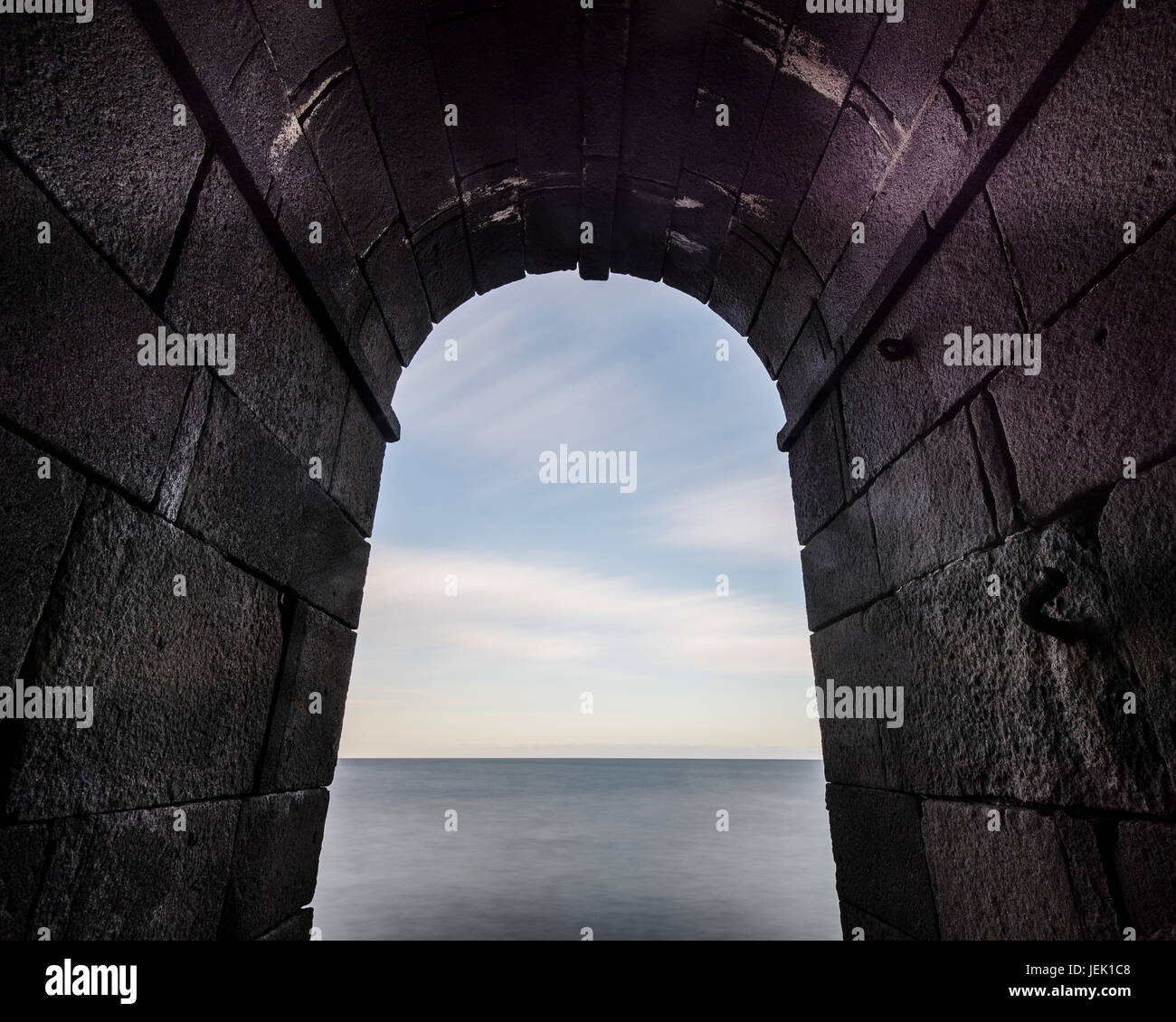Sea seen through stone arch Stock Photo - Alamy