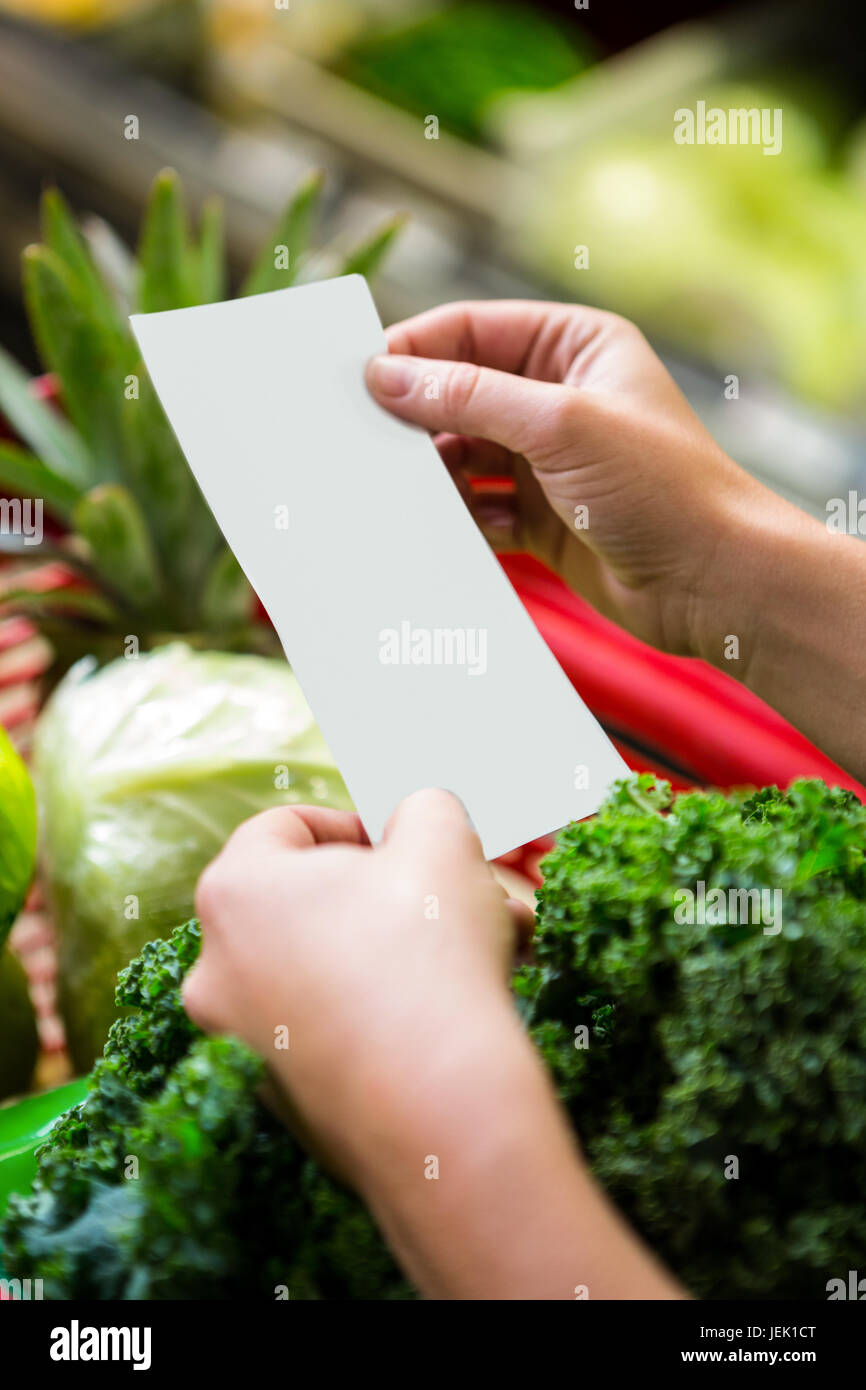 Womans hands holding list Stock Photo - Alamy