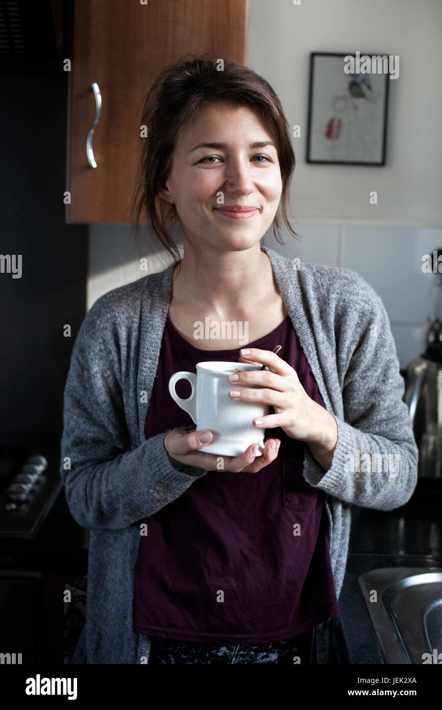 Young woman with mug Stock Photo - Alamy