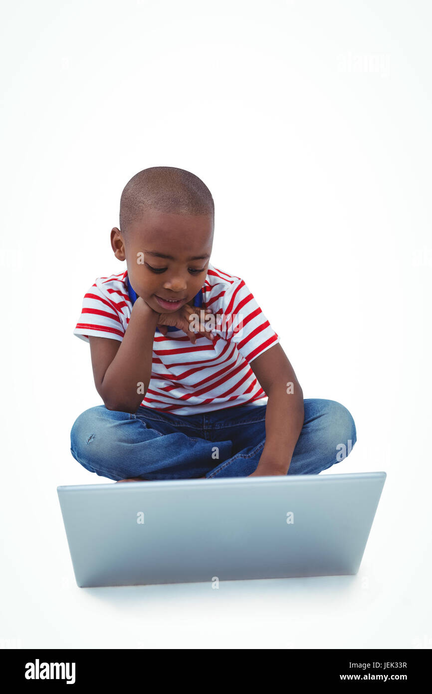 Sitting boy using laptop Stock Photo - Alamy