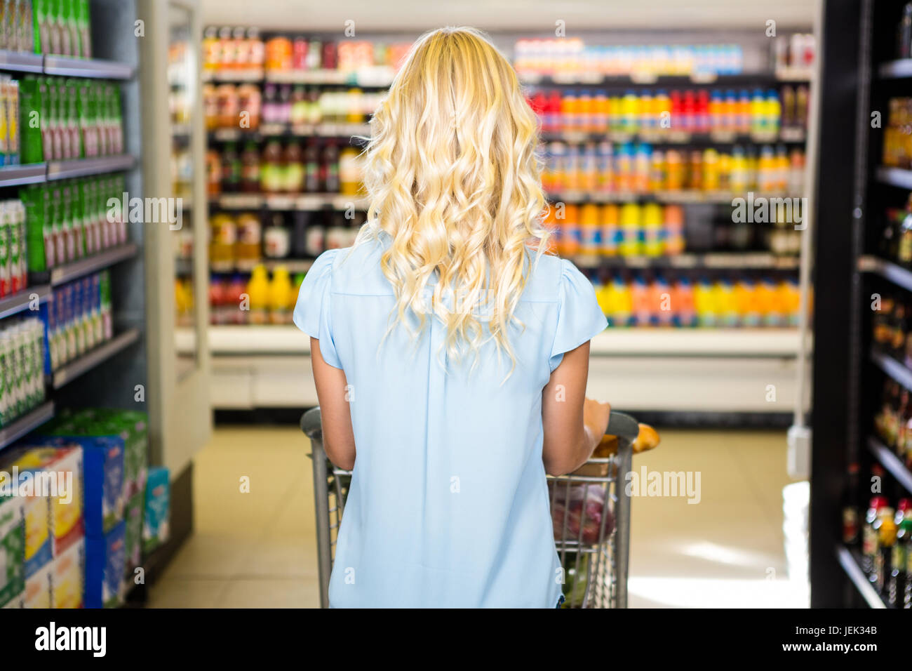 Rear view of woman pushing cart Stock Photo - Alamy