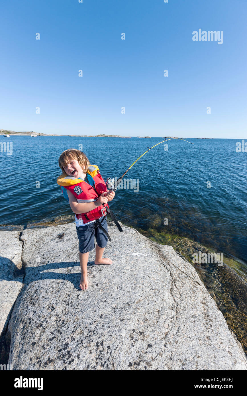 Boy fishing sea sky boys hi-res stock photography and images - Alamy