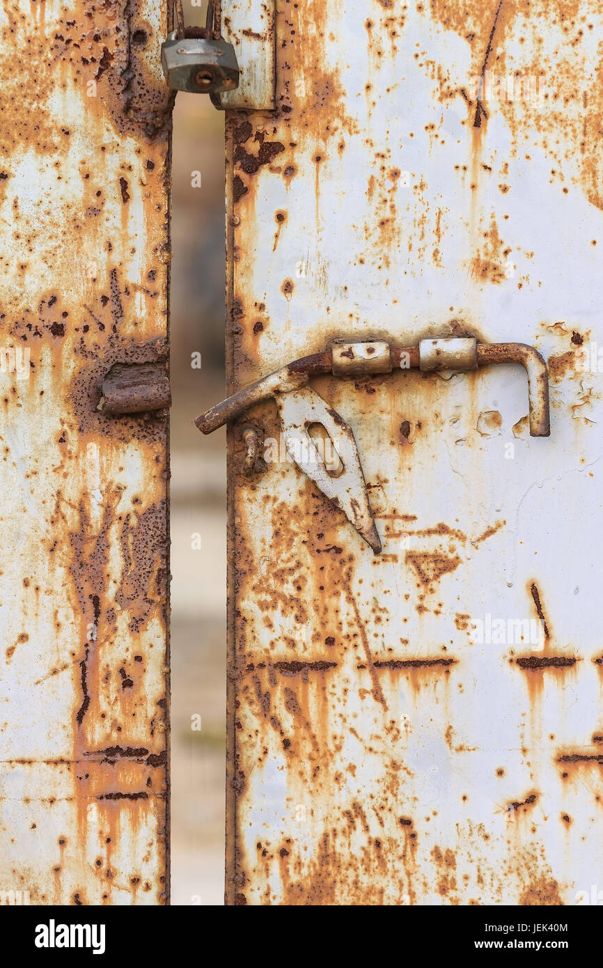 Rusty metal industrial door with sliding lock Stock Photo - Alamy
