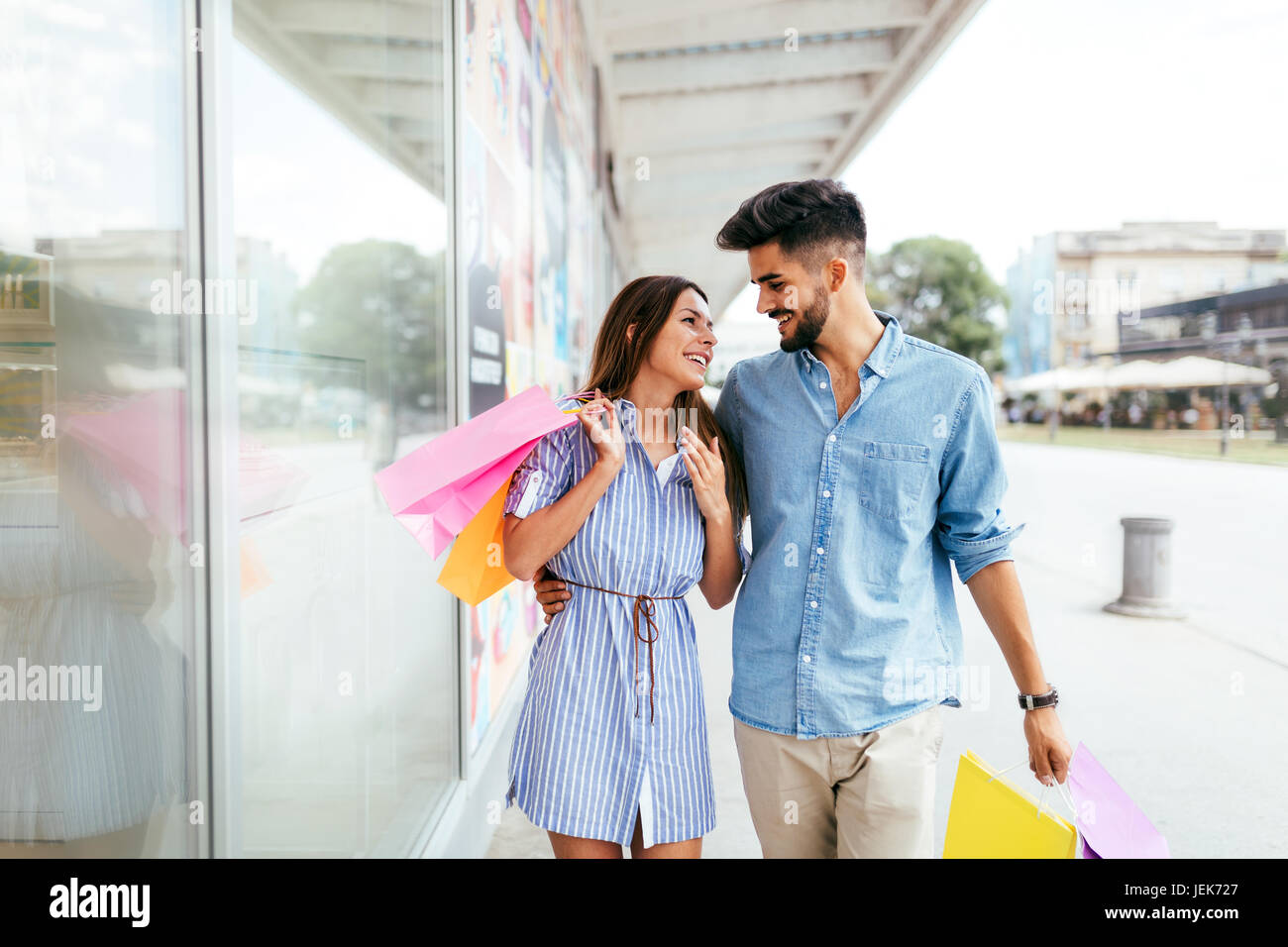 Happy attractive loving couple enjoy spending time in shopping together ...