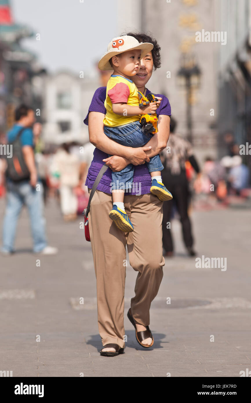 BEIJING-JUNE 9, 2015. Elder Chinese woman with grandson. To help their ...