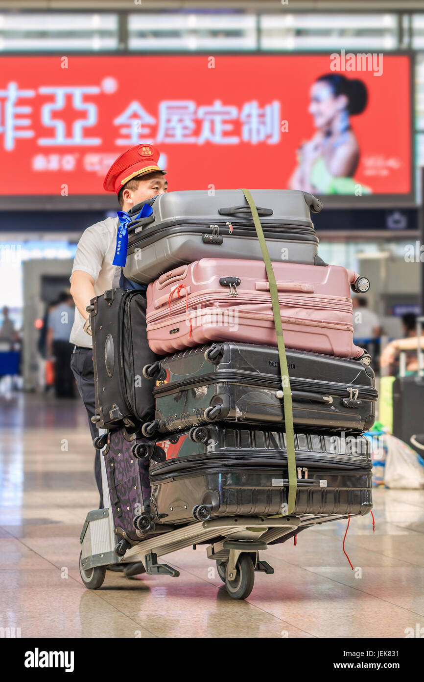 BEIJING-MAY 21, 2016. Railway porter at Beijing Railway Station South ...