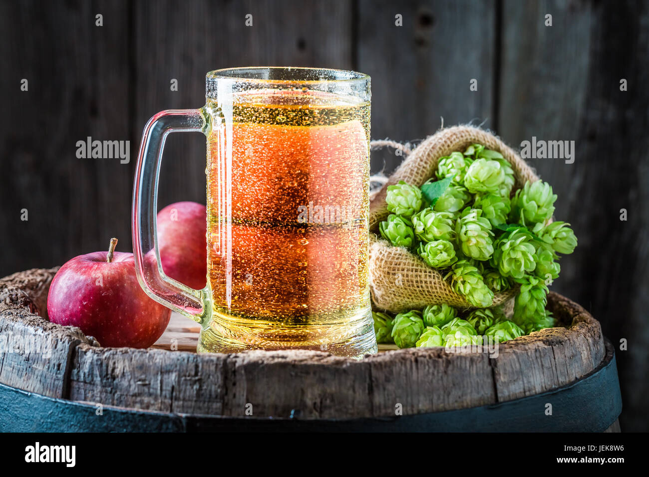 Cider beer with ingredients on old barrel Stock Photo - Alamy