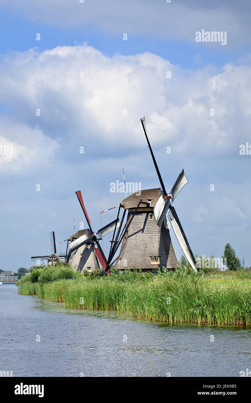 Ancient wind mills near a blue canal on a summer day at the famous ...