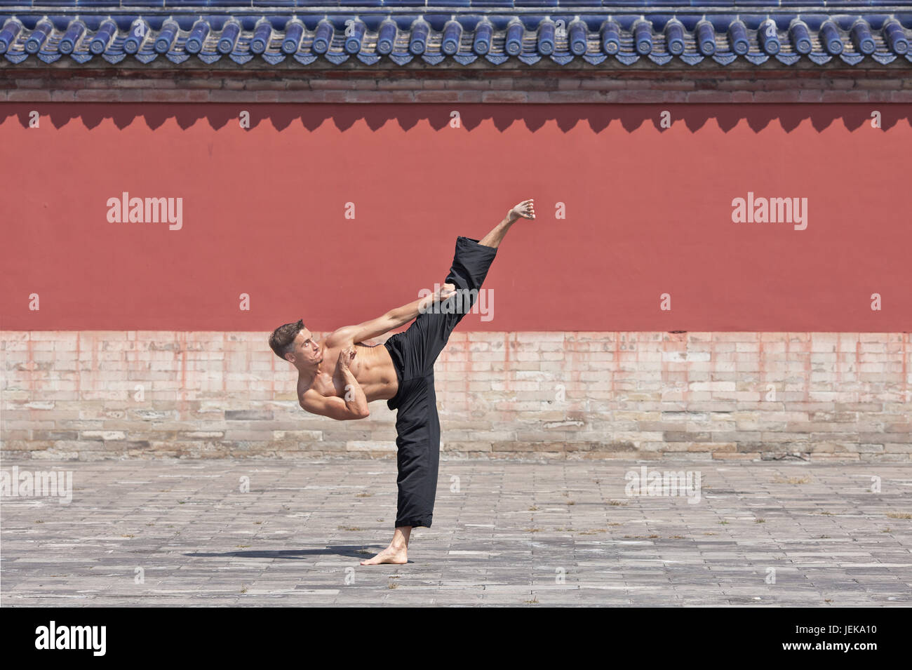 Martial arts master practising high kick technique at Temple of Heaven ...