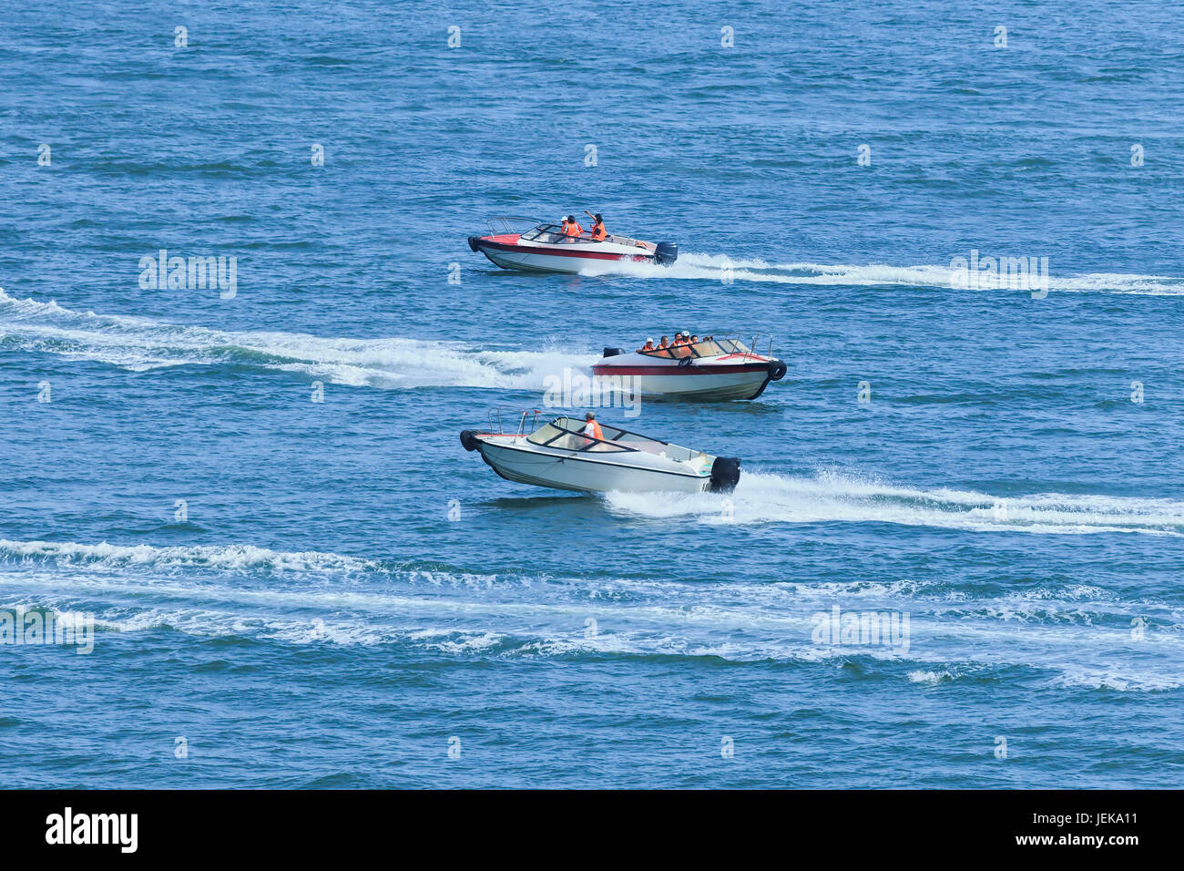 Speed boats passing each other in a blue sea Stock Photo - Alamy