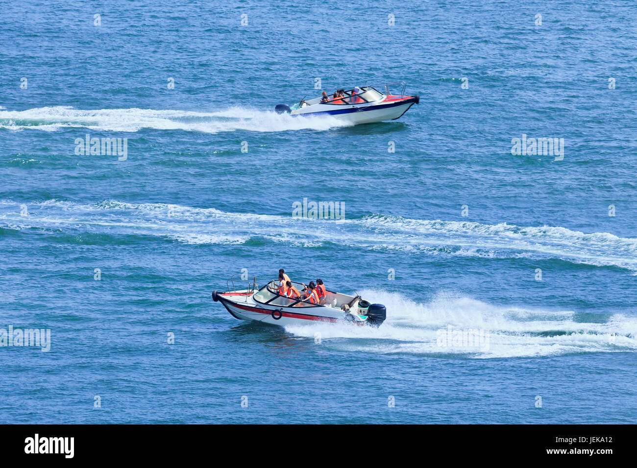 Speed boats passing each other in a blue sea Stock Photo - Alamy
