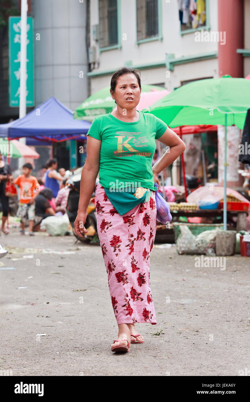 RUILI-CHINA-JUNE 28, 2014. Tanned woman on local market. Ruili is on ...