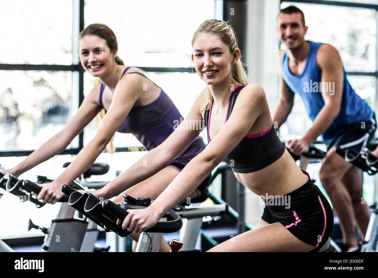 Fit people working out at spinning class Stock Photo - Alamy