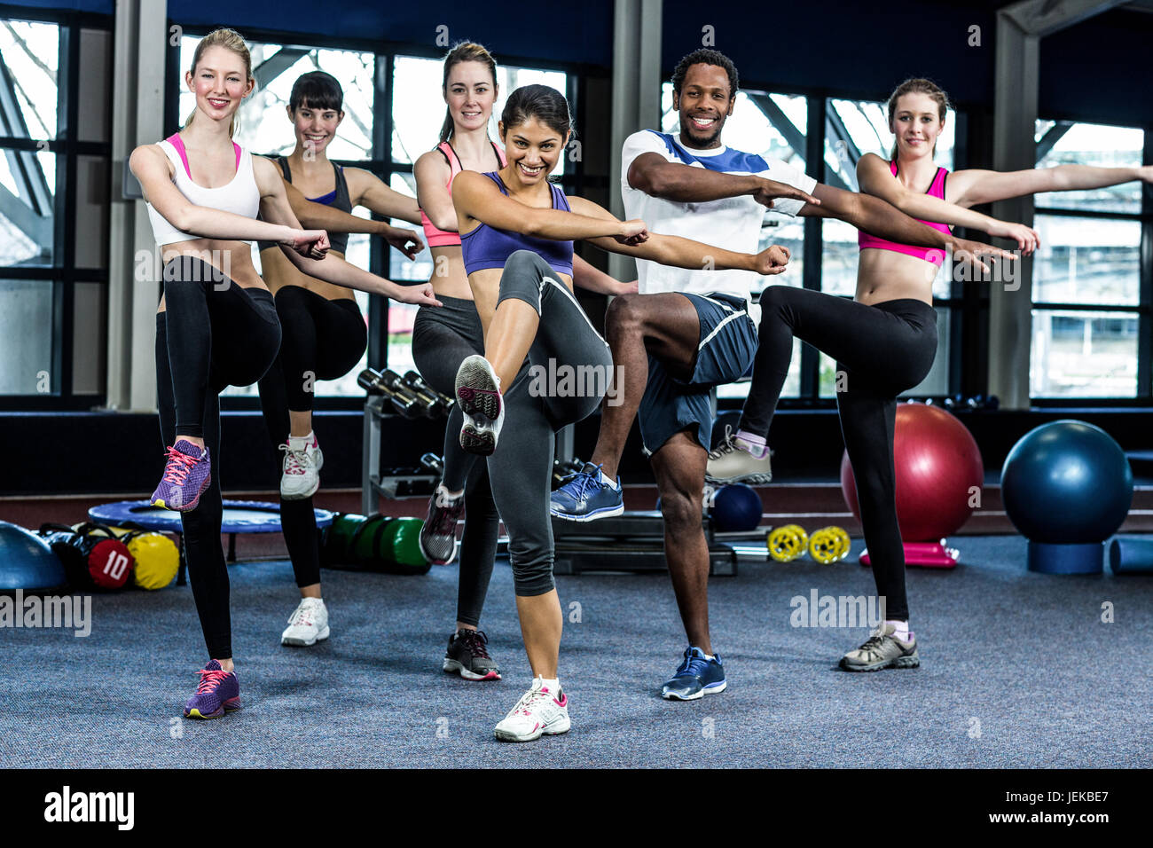 Fit smiling group doing exercise Stock Photo - Alamy