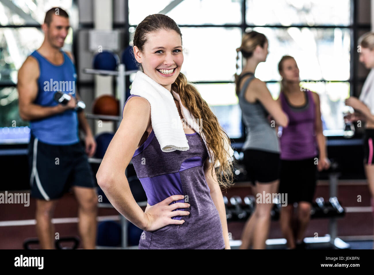 Smiling woman posing with hands on hips Stock Photo - Alamy