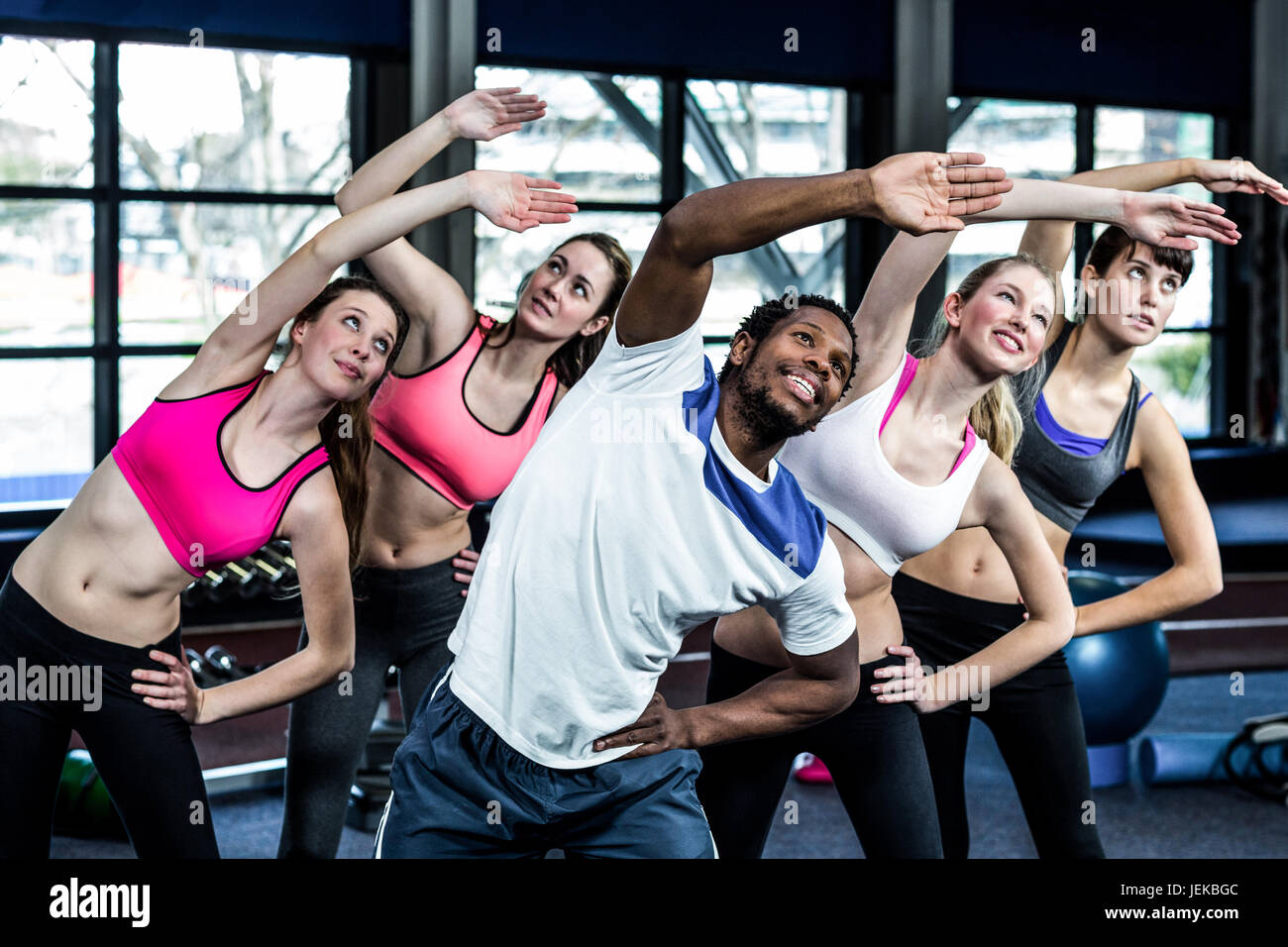 Fit smiling group doing exercise Stock Photo - Alamy