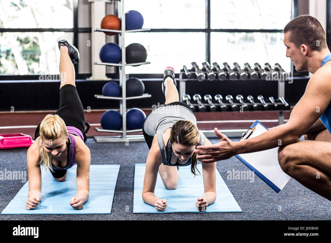 Fitness class doing exercises on mat Stock Photo - Alamy