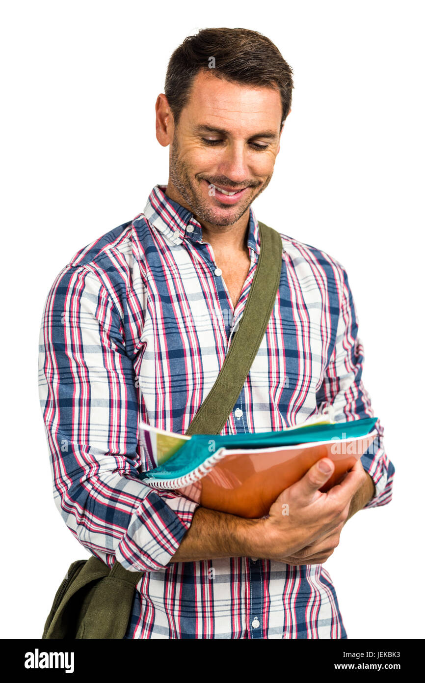 Smiling man standing with notepads Stock Photo - Alamy