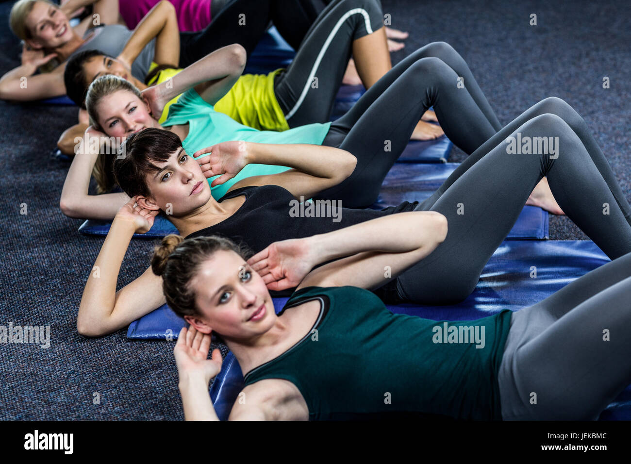 Fit smiling group working abs Stock Photo - Alamy