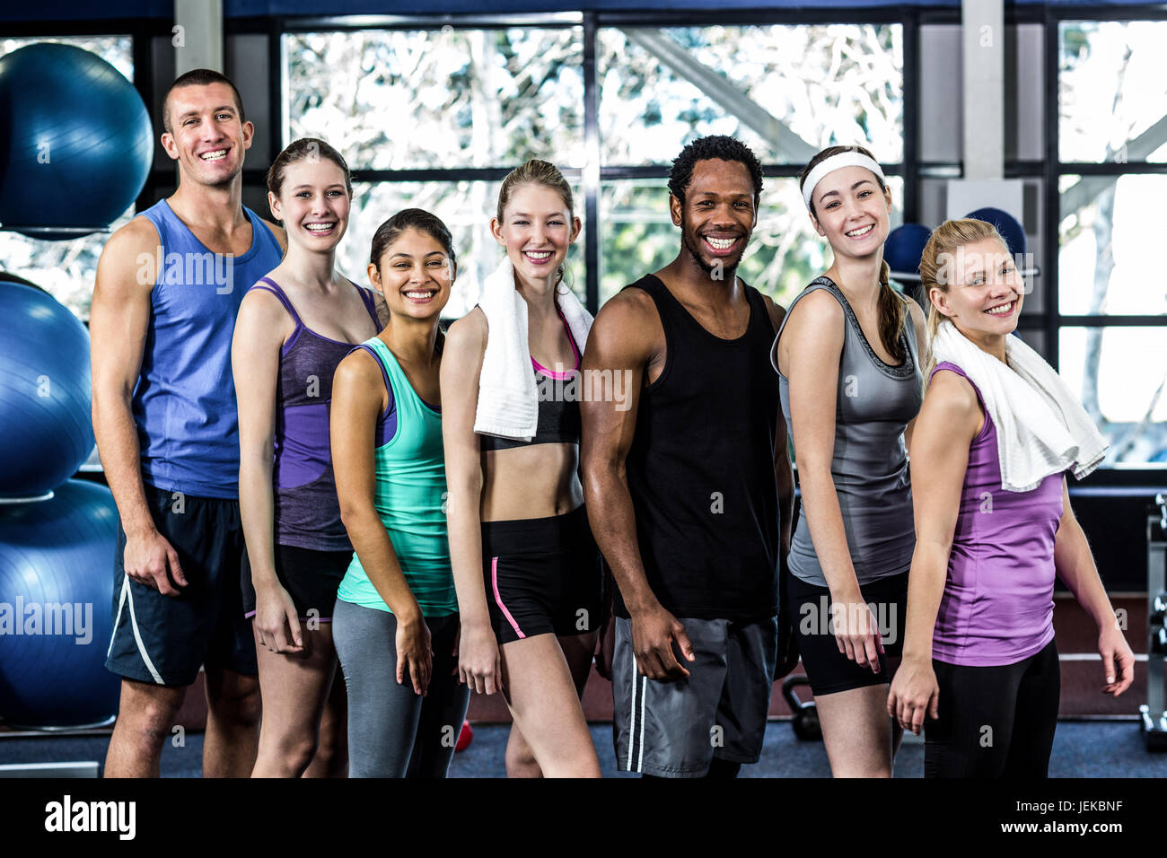 Smiling fitness class posing together Stock Photo - Alamy