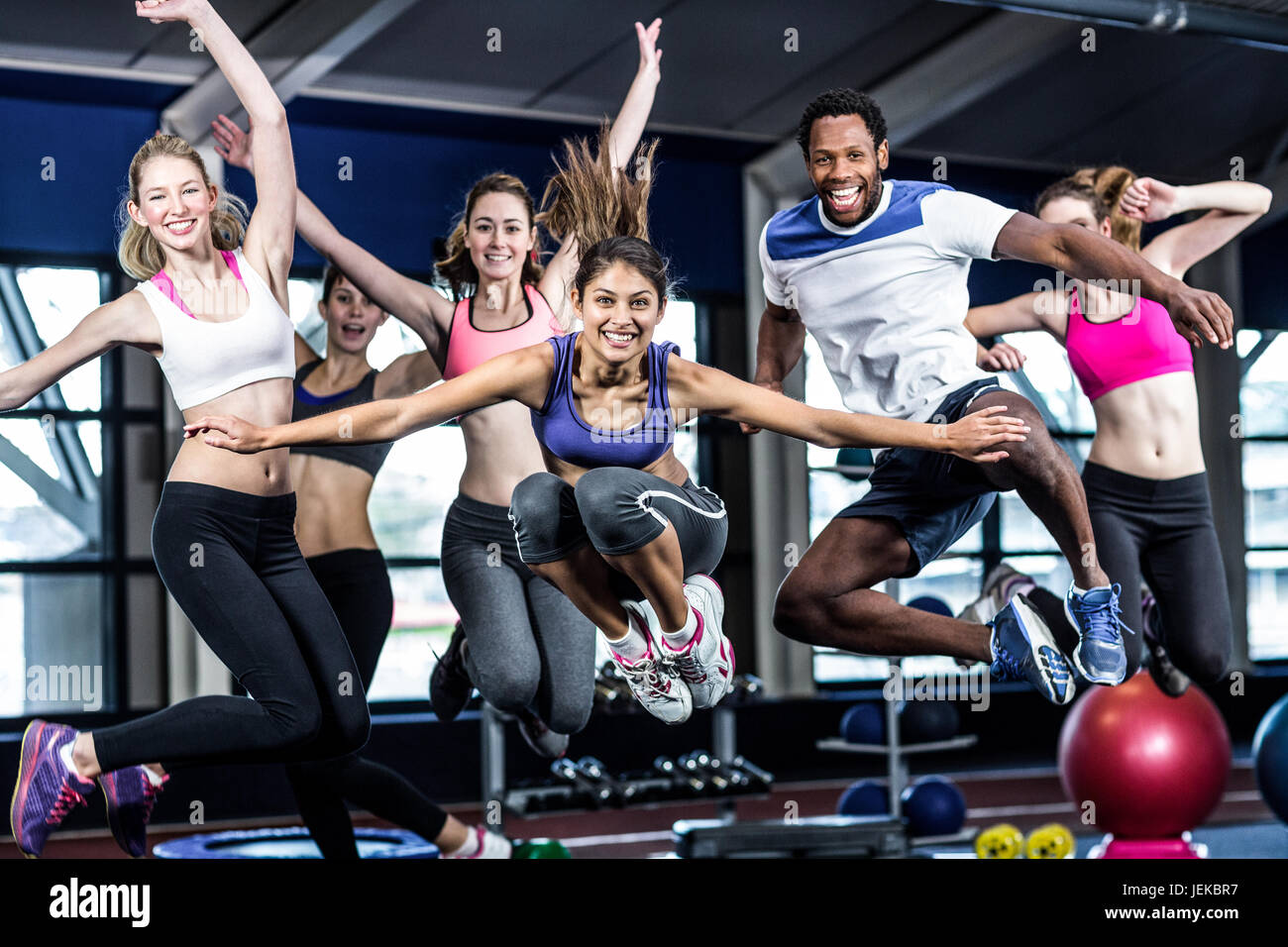 Fit group smiling and jumping Stock Photo - Alamy