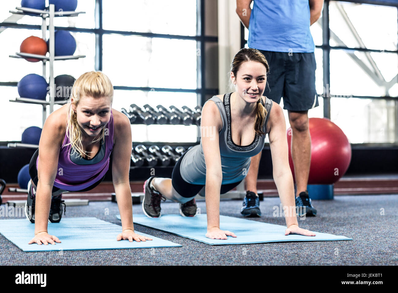 Fitness class doing exercises on mat Stock Photo - Alamy