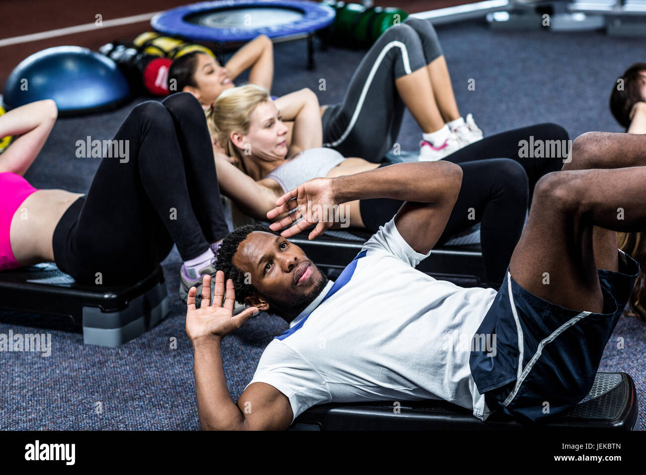 Group of people working their abs Stock Photo - Alamy