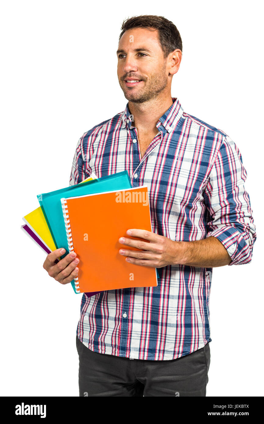 Smart man standing holding notepads Stock Photo - Alamy