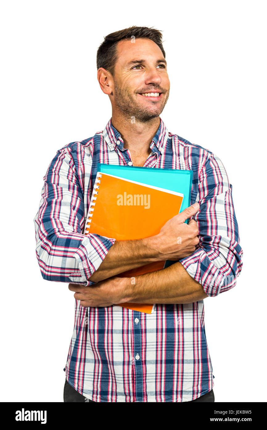 Man standing and holding notepads Stock Photo - Alamy