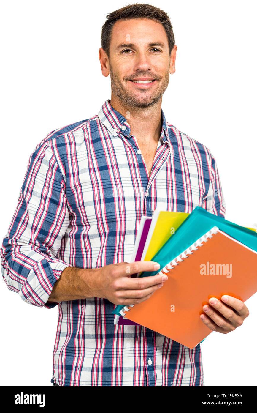 Confident man standing holding notepads Stock Photo - Alamy