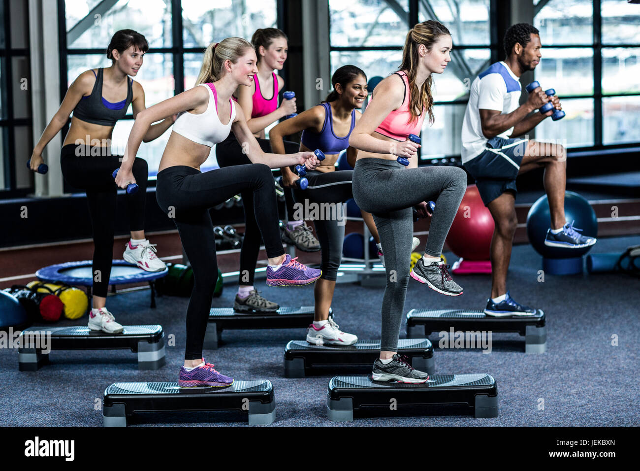 Fit smiling group doing exercise Stock Photo - Alamy