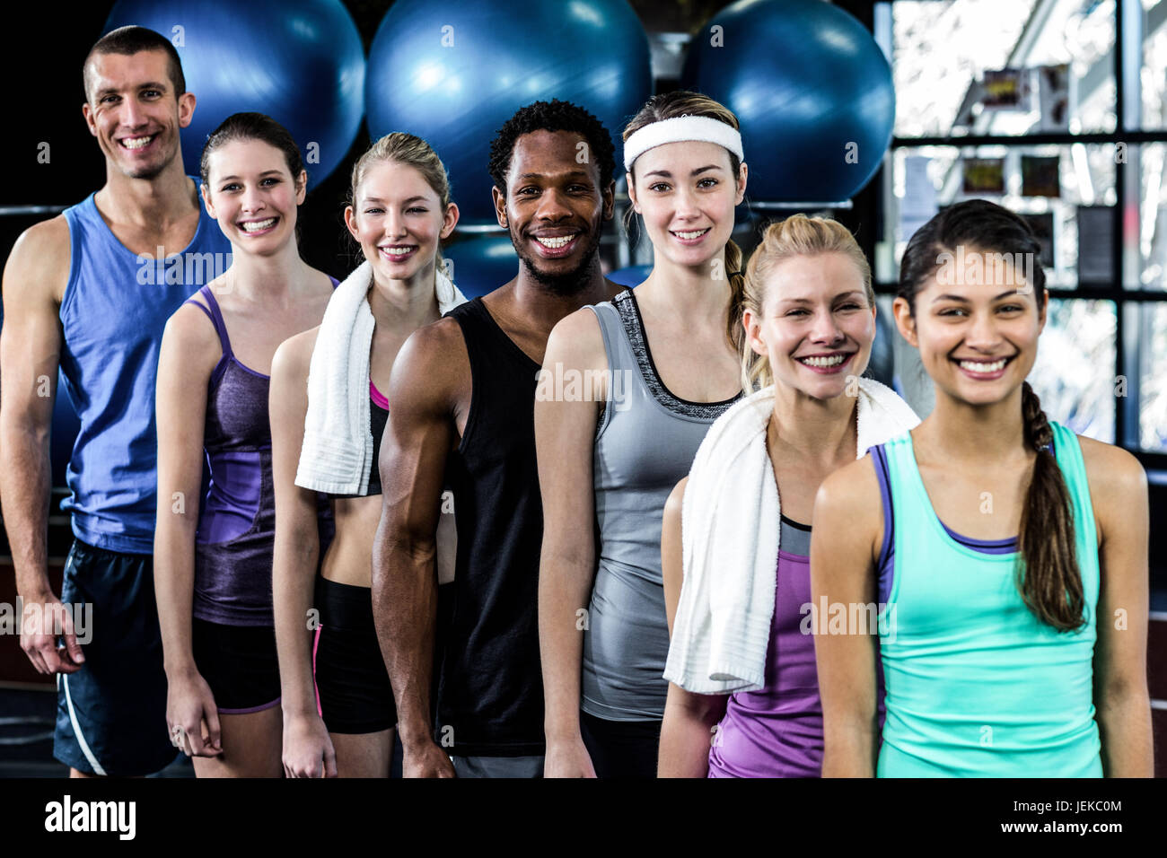 Smiling fitness class posing together Stock Photo - Alamy