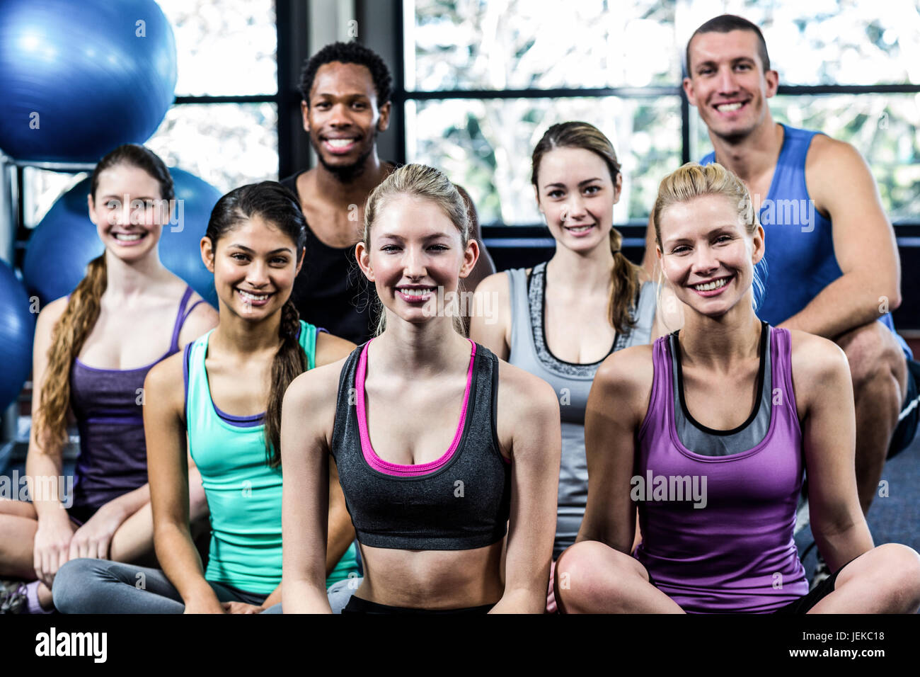 Smiling fitness class posing together Stock Photo - Alamy