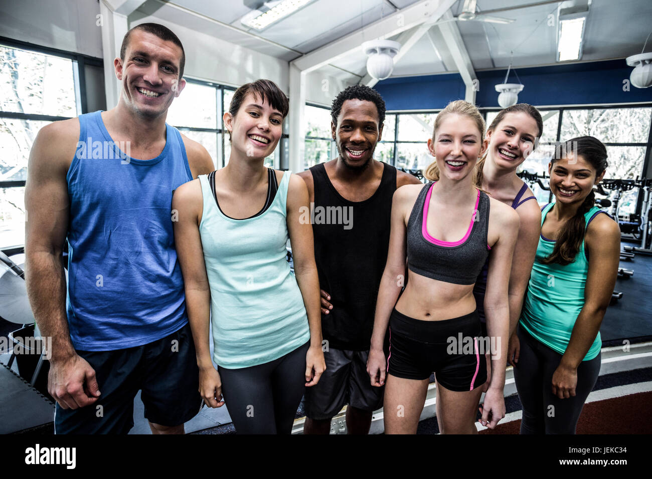 Smiling fitness class posing together Stock Photo - Alamy