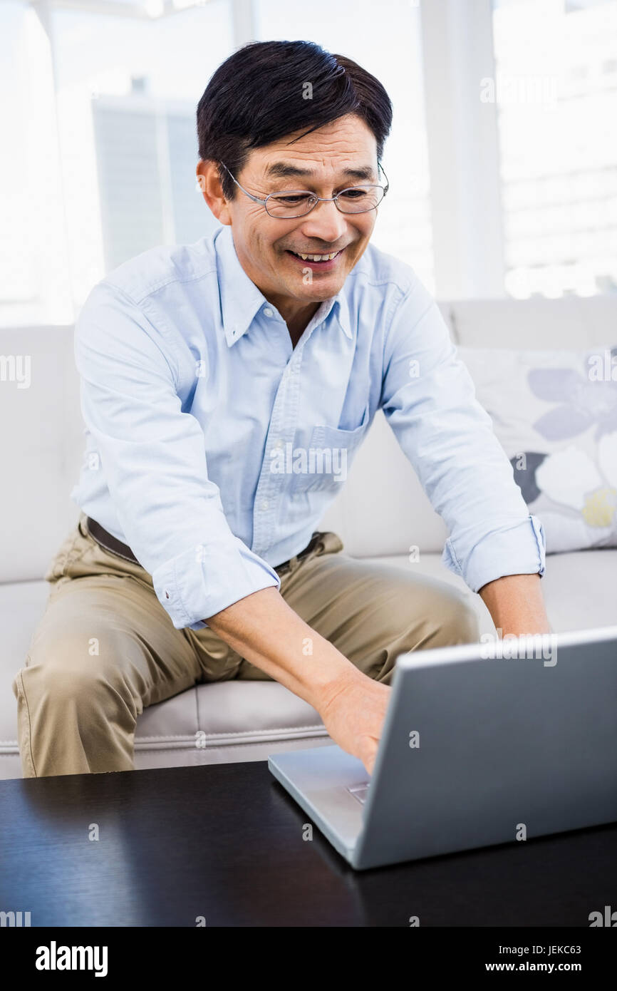 Happy man sitting at home Stock Photo - Alamy
