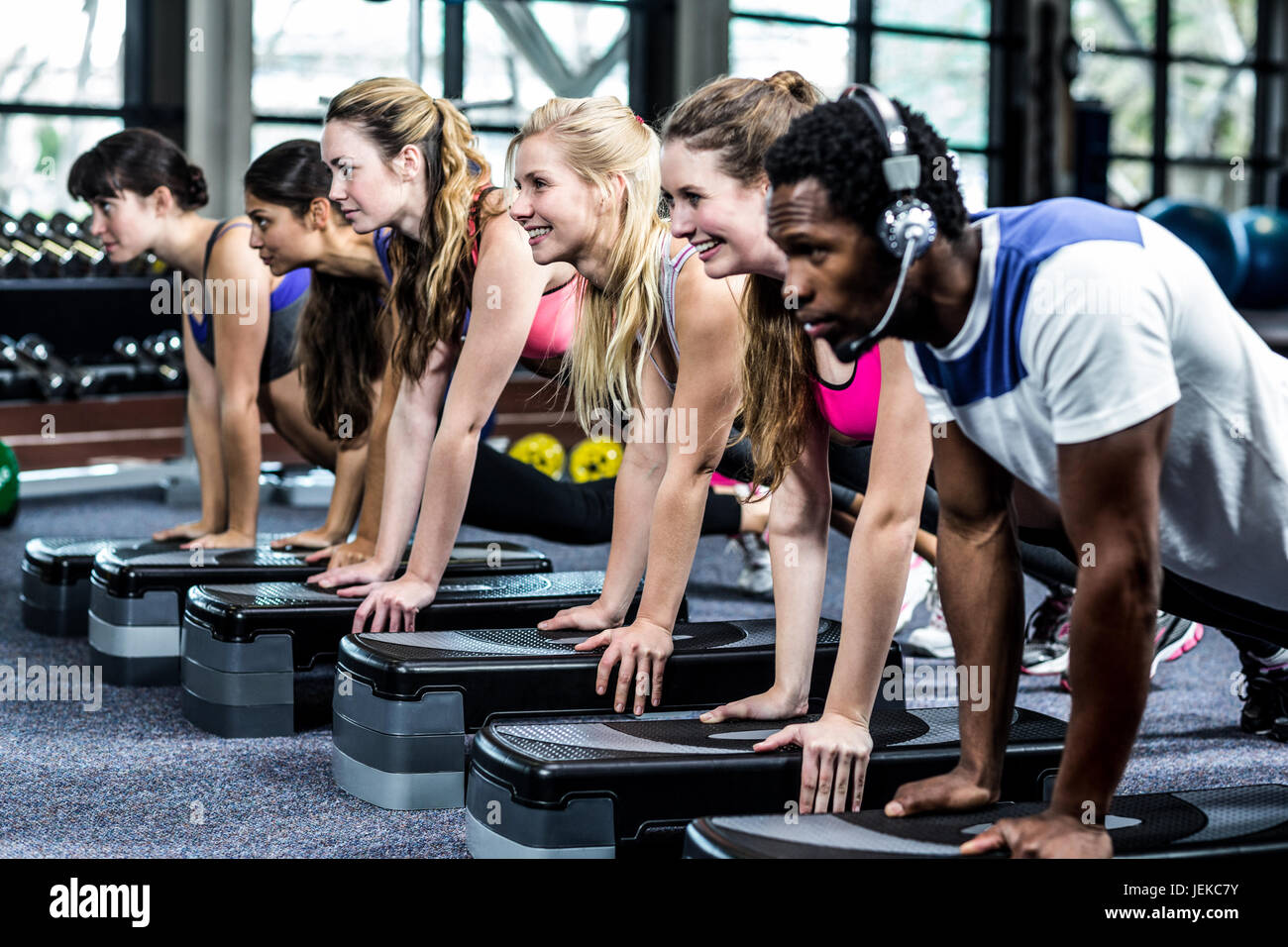 Group of fit people doing some push ups Stock Photo - Alamy