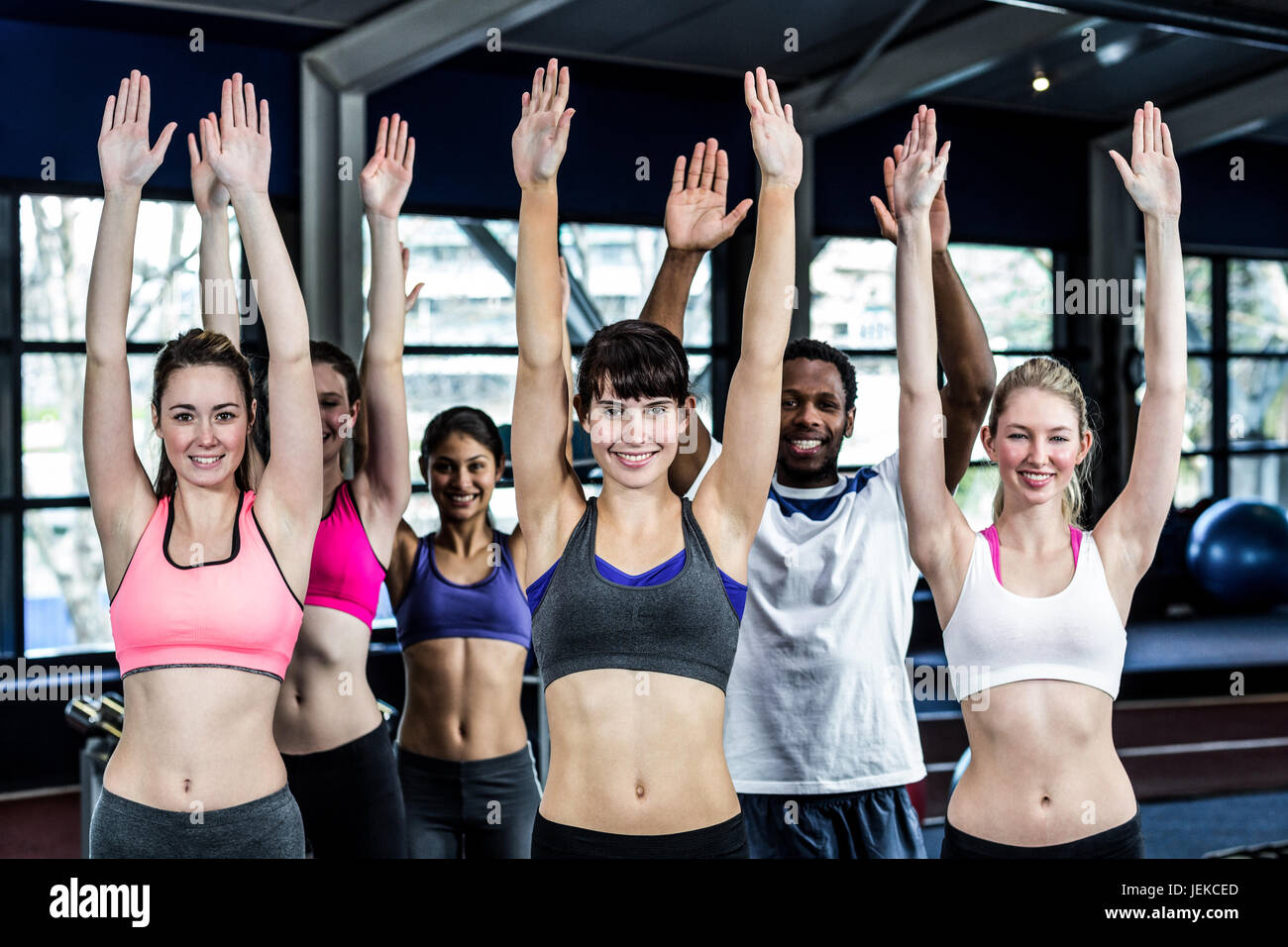 Fit smiling group doing exercise Stock Photo - Alamy