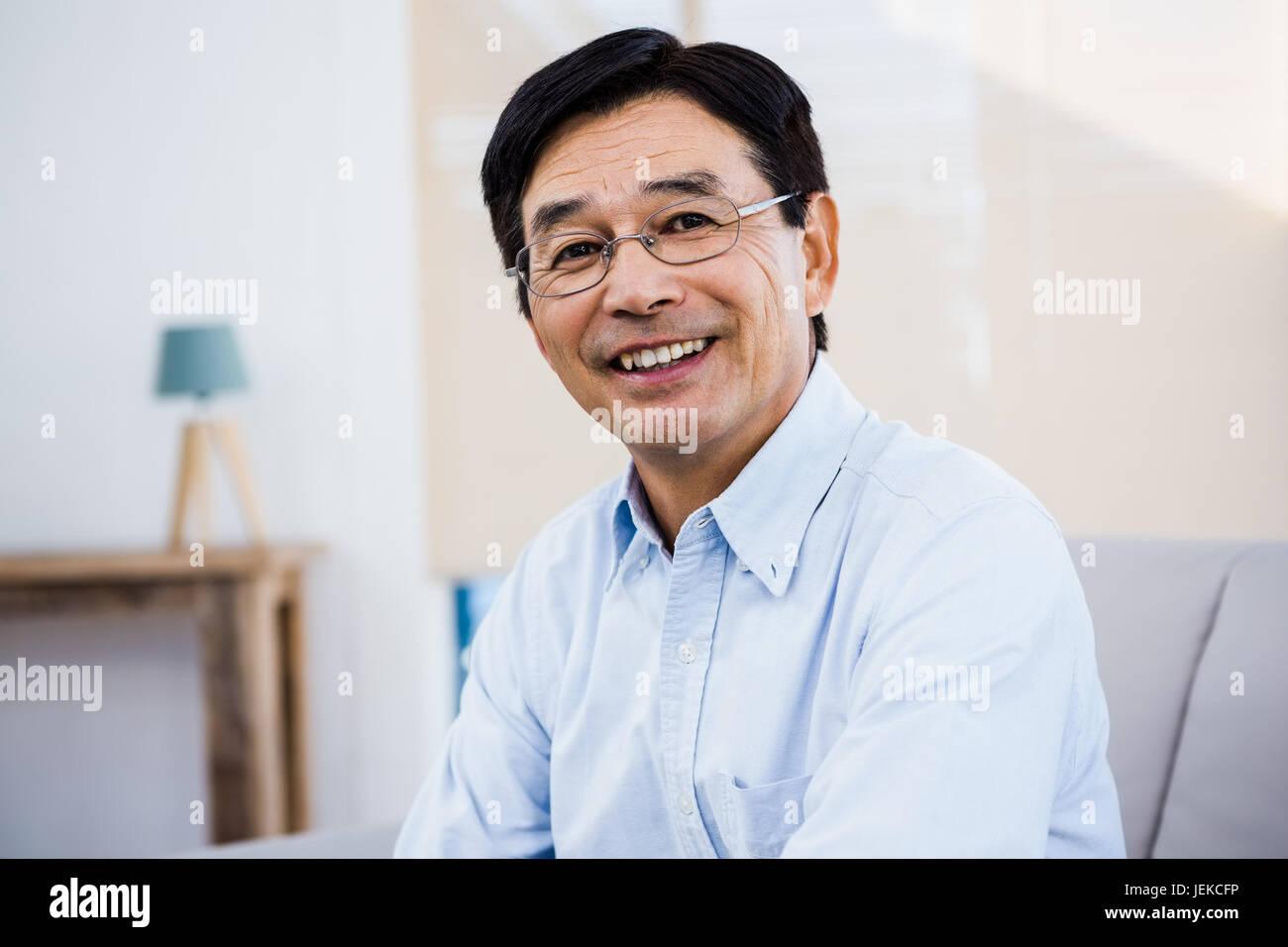 Happy man sitting at home Stock Photo - Alamy