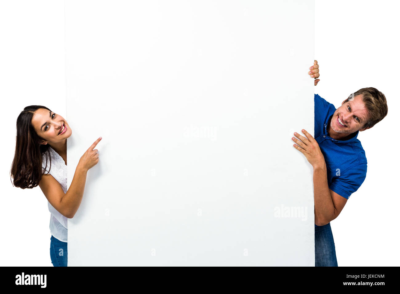 Smiling couple behind board Stock Photo - Alamy