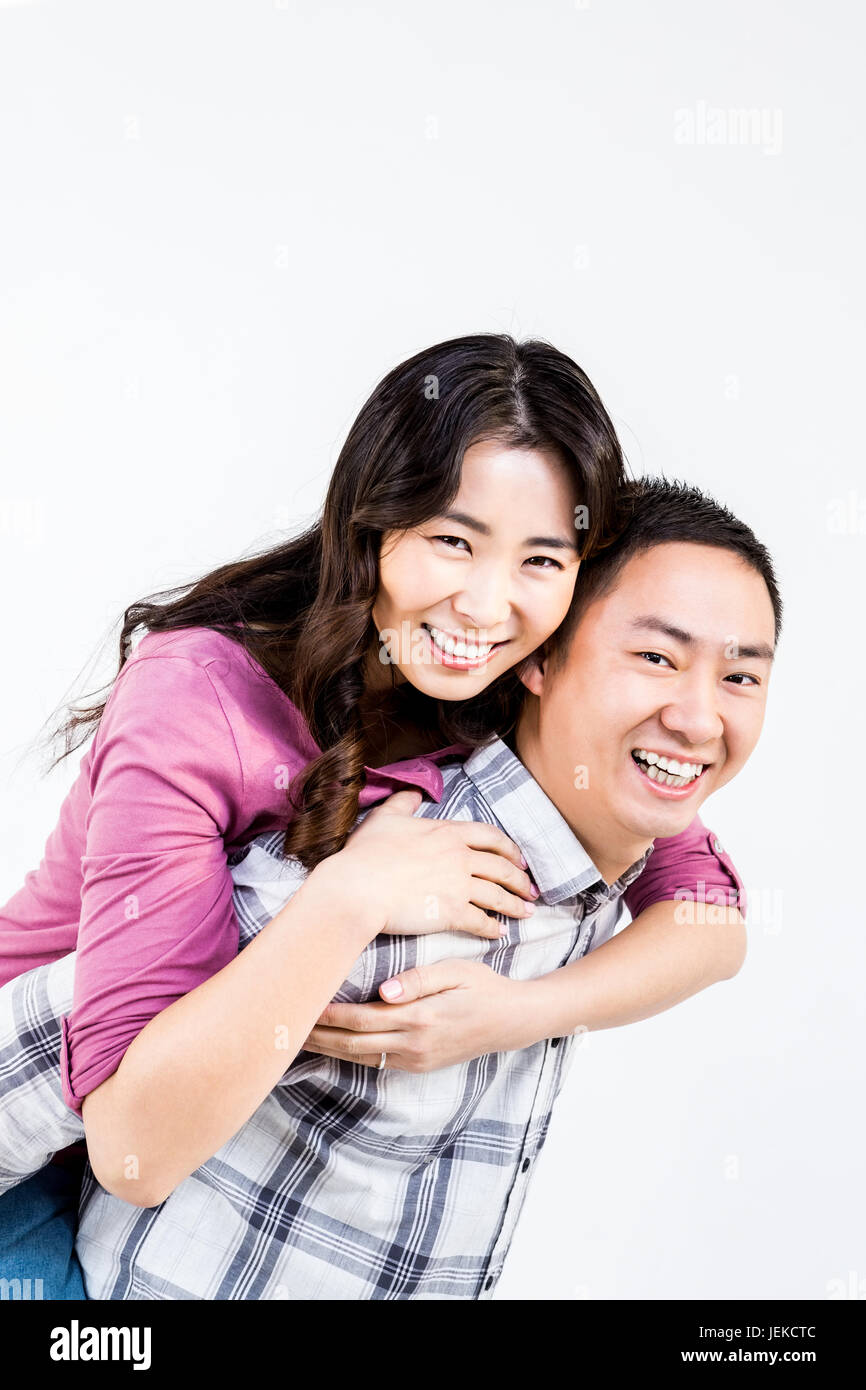 Man giving woman a piggyback Stock Photo - Alamy