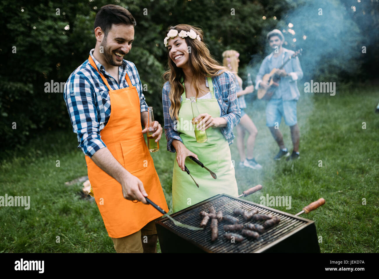 Cheerful friends spending time in nature and having barbecue Stock ...